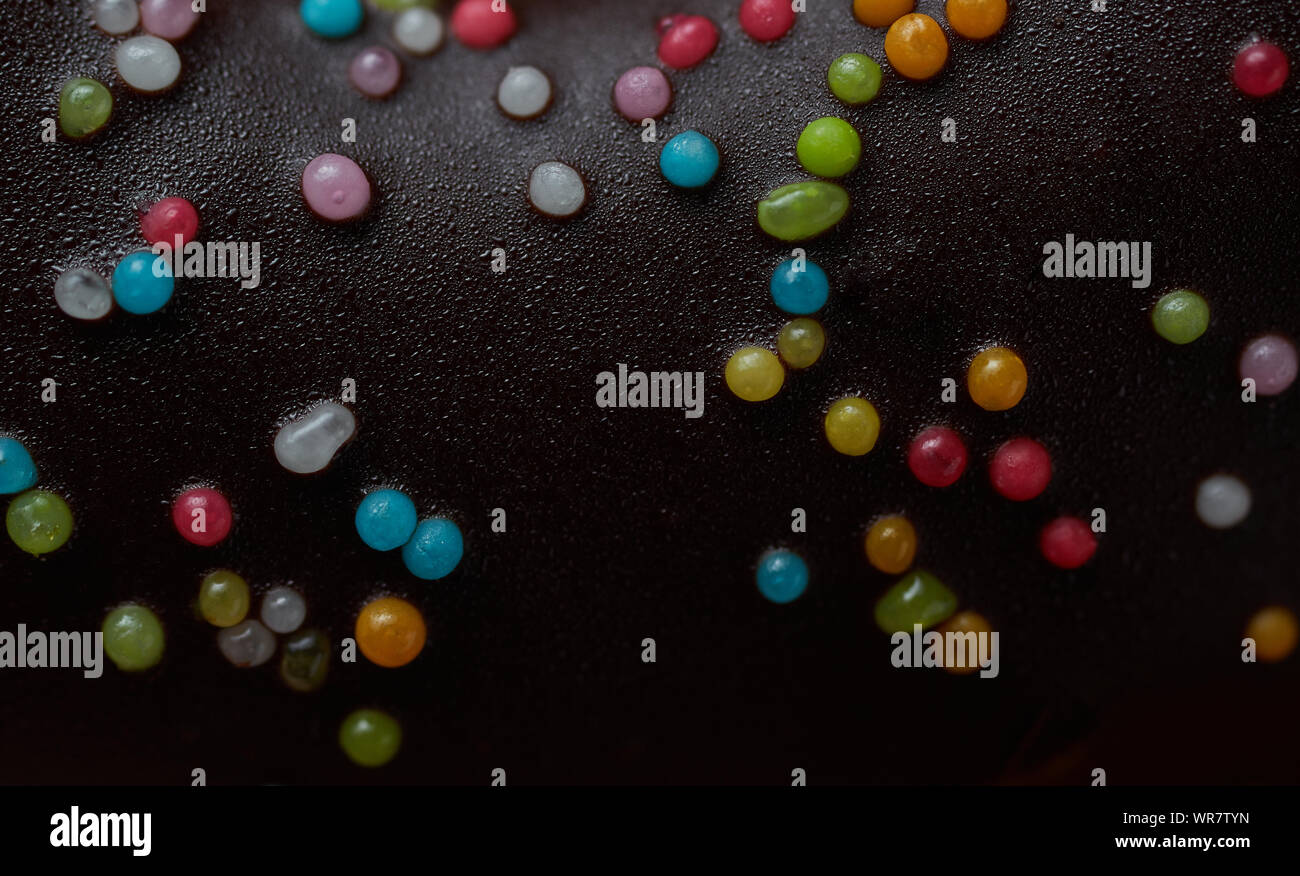 Colorful topping on chocolate surface of the dessert Stock Photo - Alamy