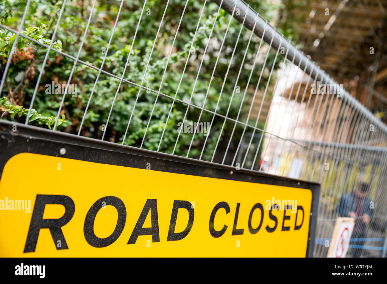 Road closed sign. Building site. Security fence and scafolding. City ...