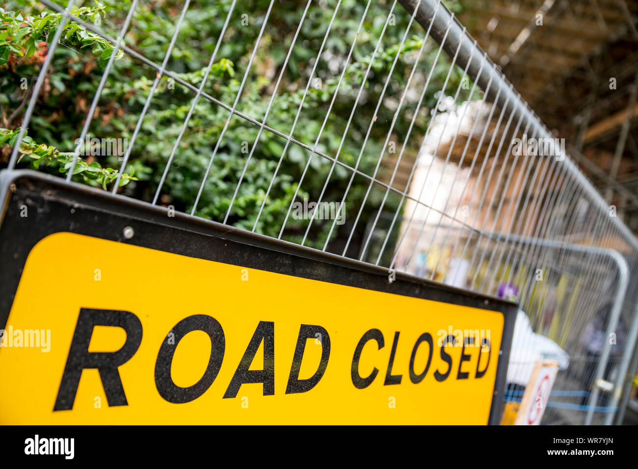 Road closed sign. Building site. Security fence and scafolding. City ...