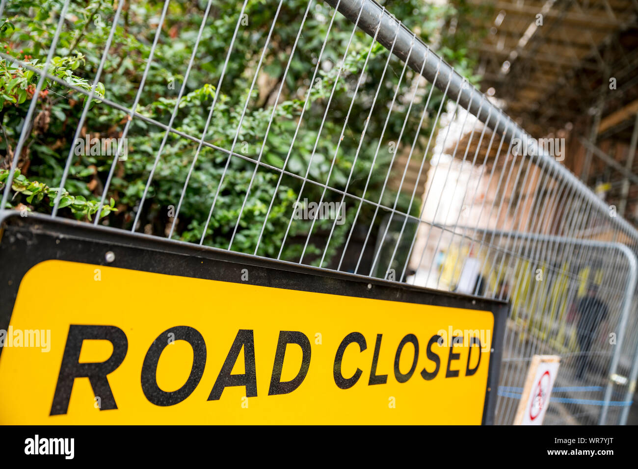 Road closed sign. Building site. Security fence and scafolding. City ...