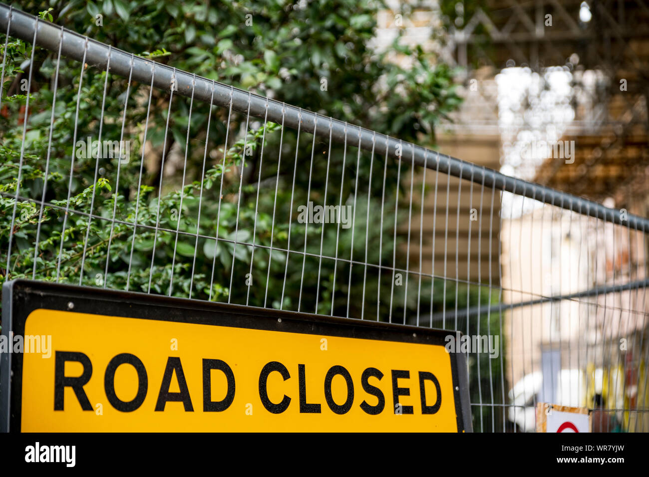 Road closed sign. Building site. Security fence and scafolding. City ...