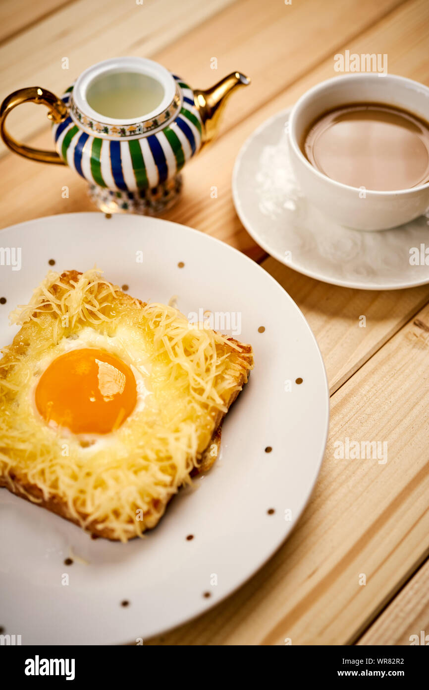 breakfast set with coffee and toast with egg on wooden table Stock ...
