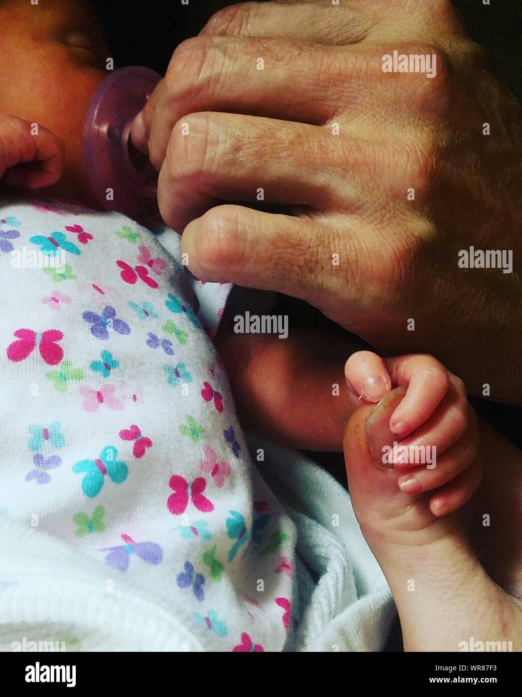 Toddler hand pacifier hi-res stock photography and images - Alamy