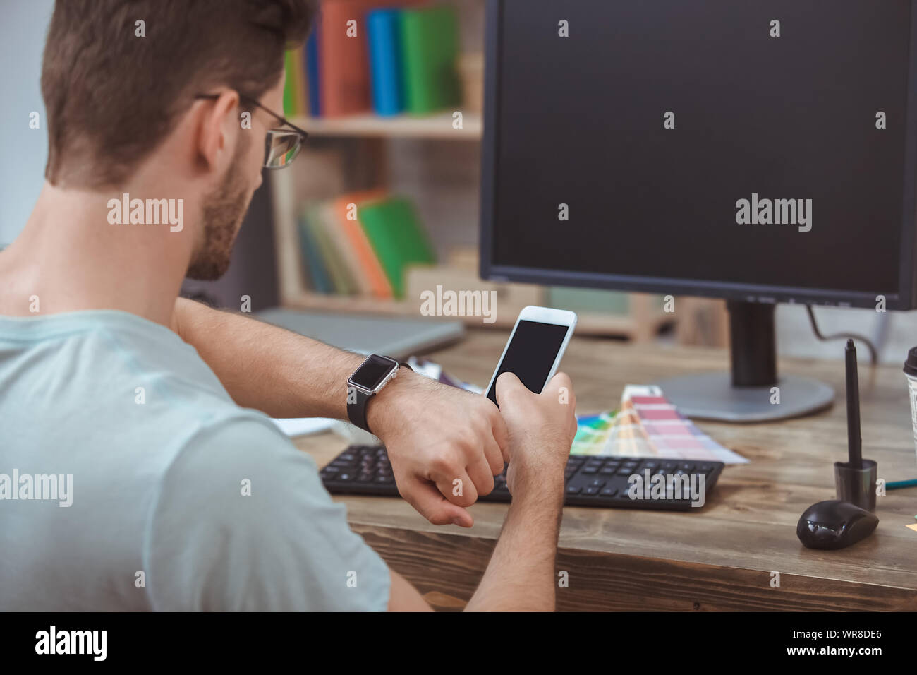 Graphic designer small business home office concept checking time Stock ...