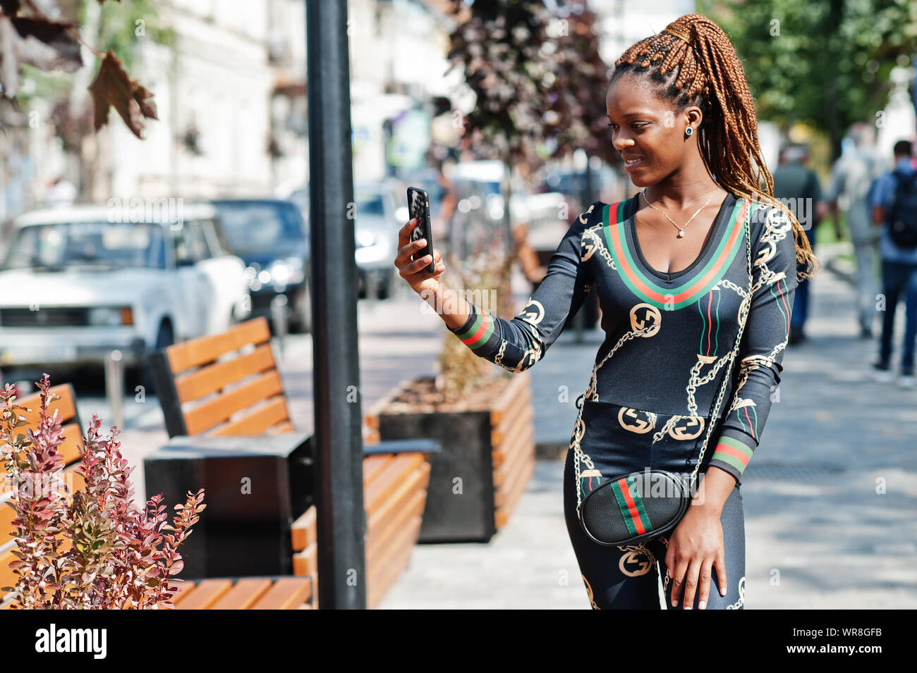 Portrait of handsome stylish african american model woman with cell ...