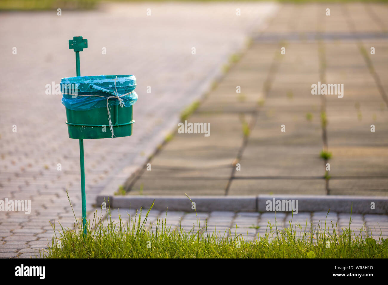 Garbage bin outdoor on blurred sunny background Stock Photo - Alamy