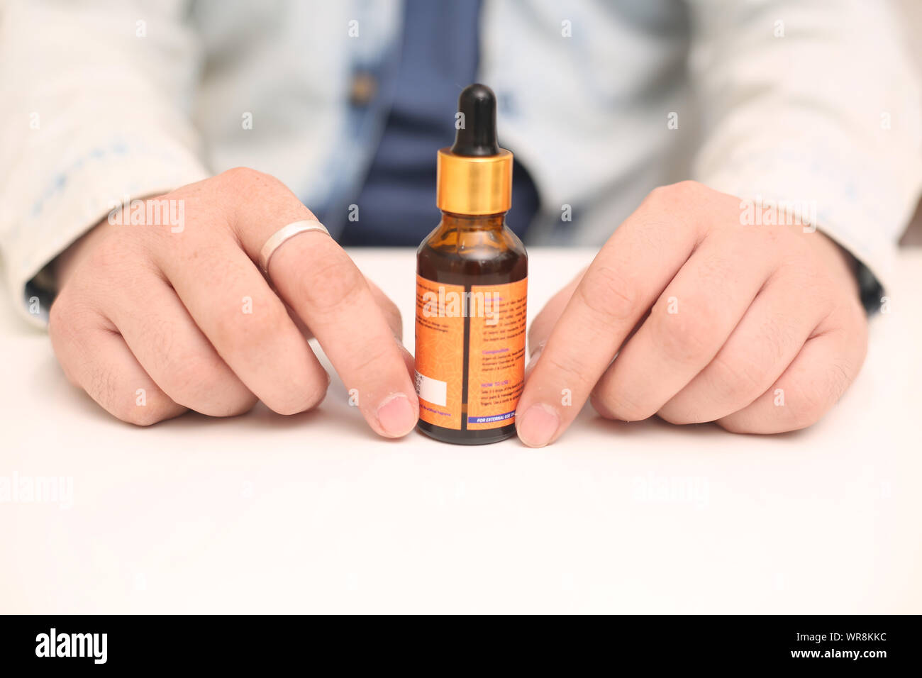 Picture of man drop medicine bottle holding in hand. Isolated on white ...