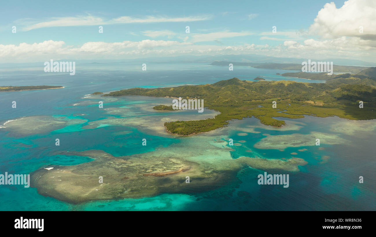 Tropical landscape: islands and atolls with blue water against the sky ...