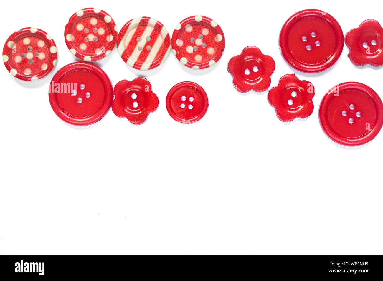 Various red sewing buttons isolated on background with place for text ...