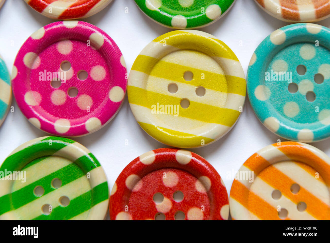 Full frame photo of various colorful sewing buttons on white background ...