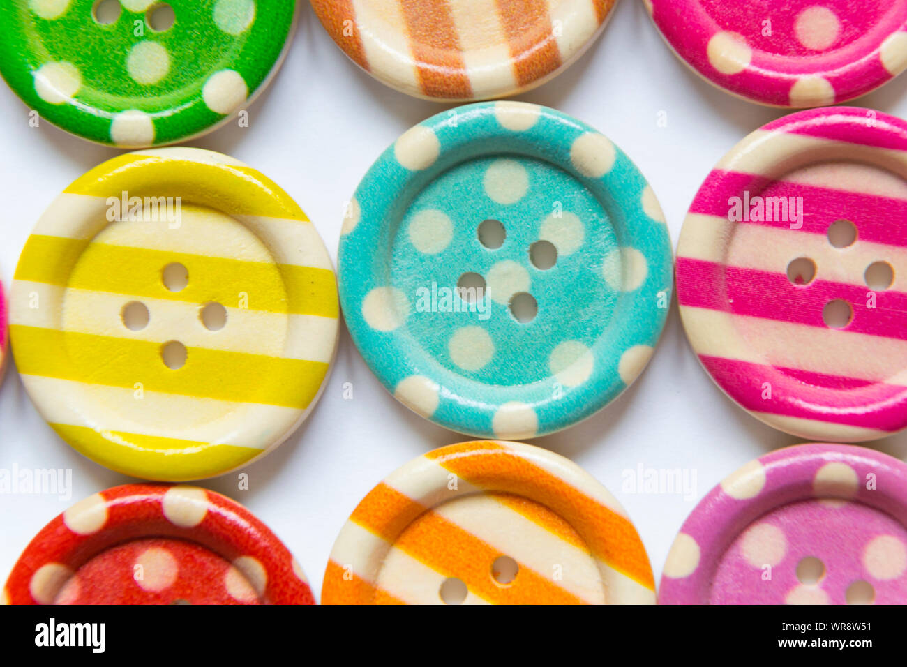Full frame photo of various colorful sewing buttons on white background ...