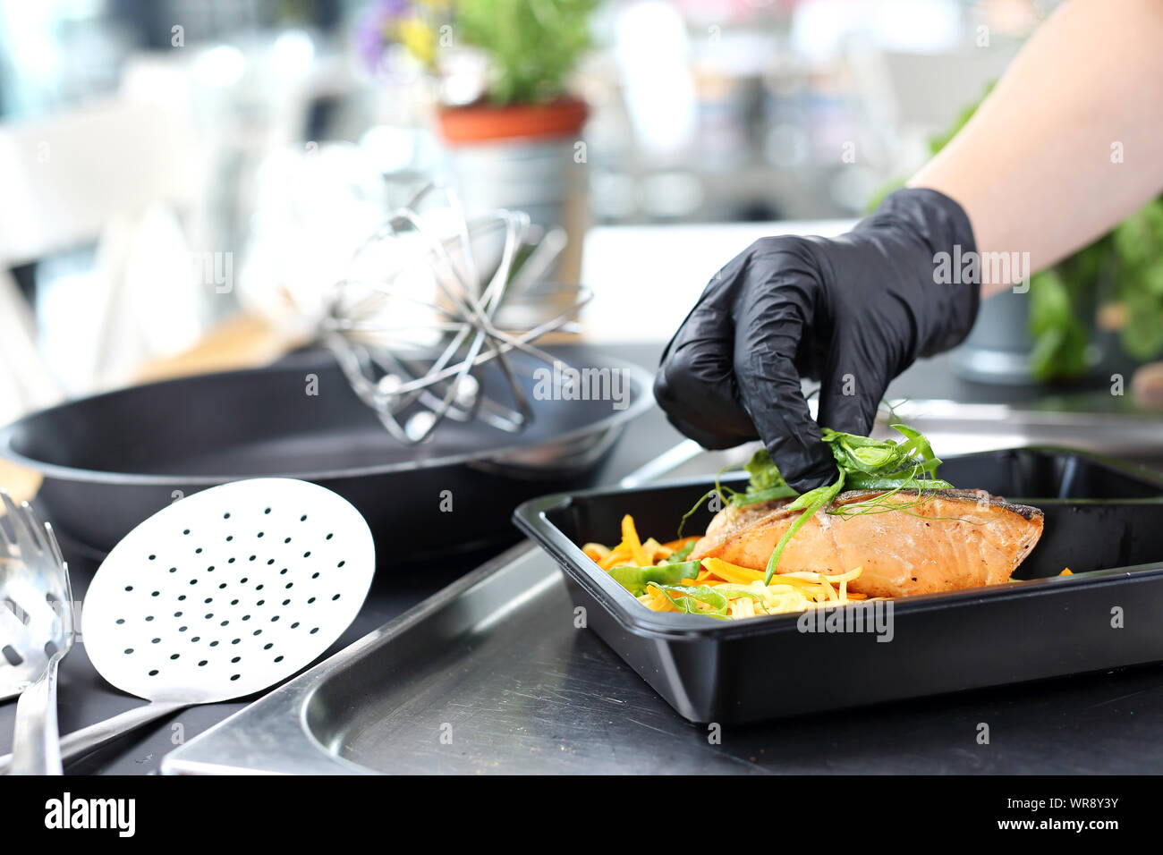Catering. Meal prep.The cook prepares take-out dishes Stock Photo - Alamy