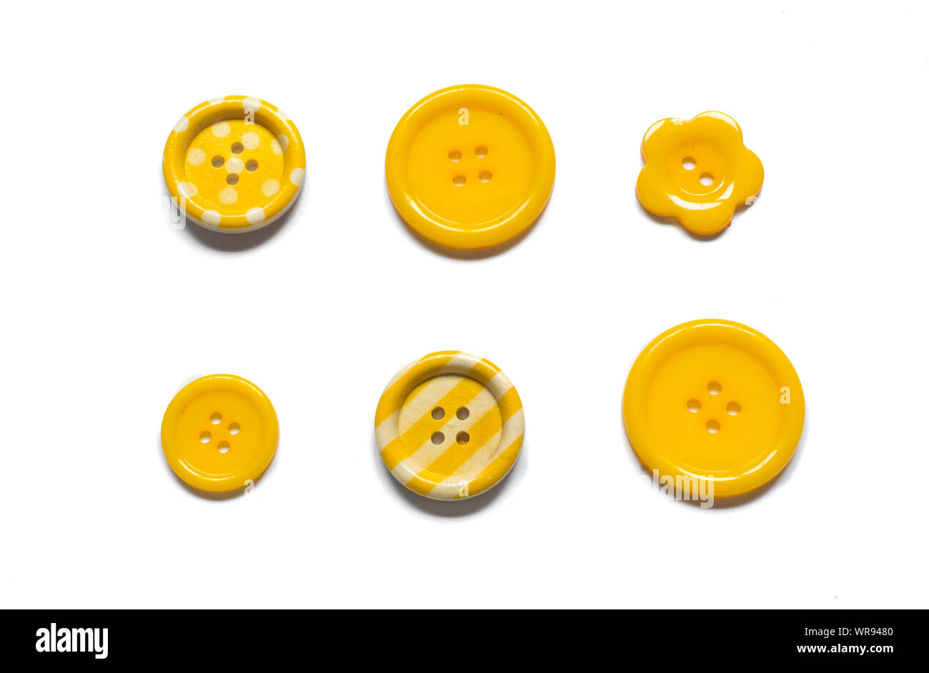 Various yellow sewing buttons isolated on white background Stock Photo ...