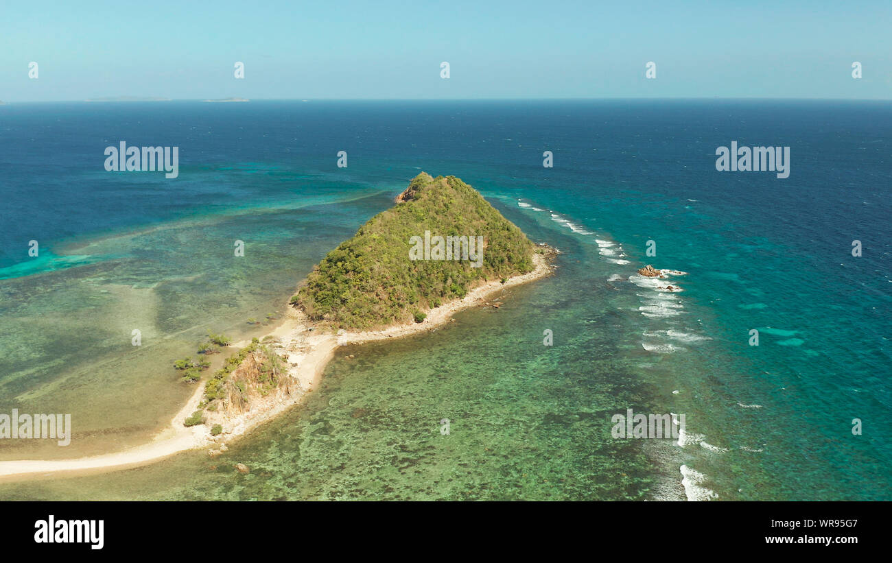 aerial view tropical island in blue lagoon, coral reef and big wave ...