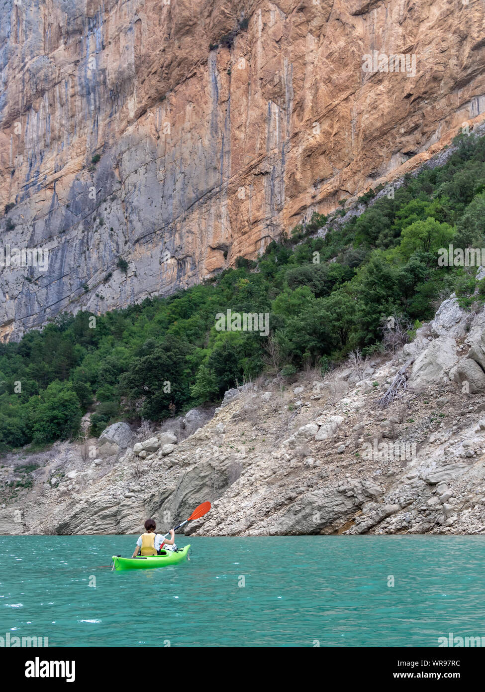 Tourist girl in a sit on top kayak explores Congost de Mont-rebei (Mont ...