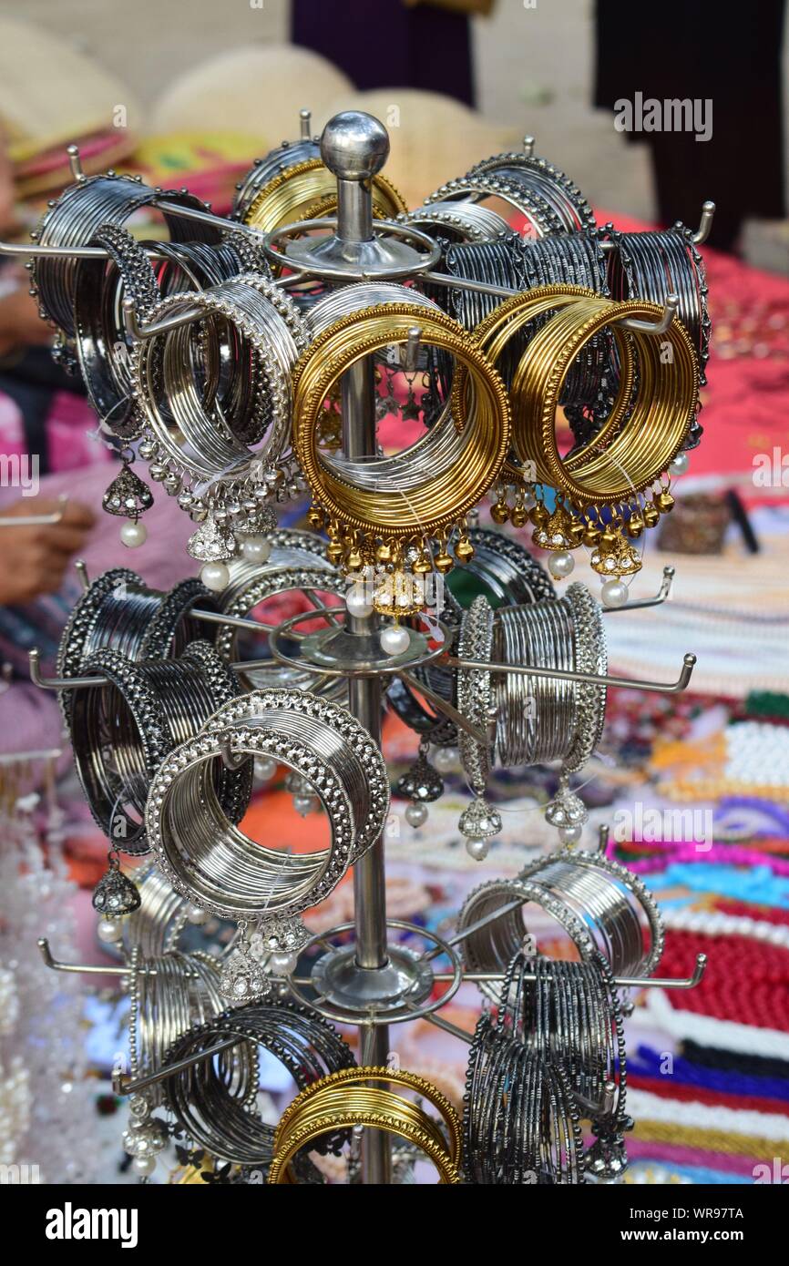 Bangles and bracelets made from metals and city gold Stock Photo - Alamy