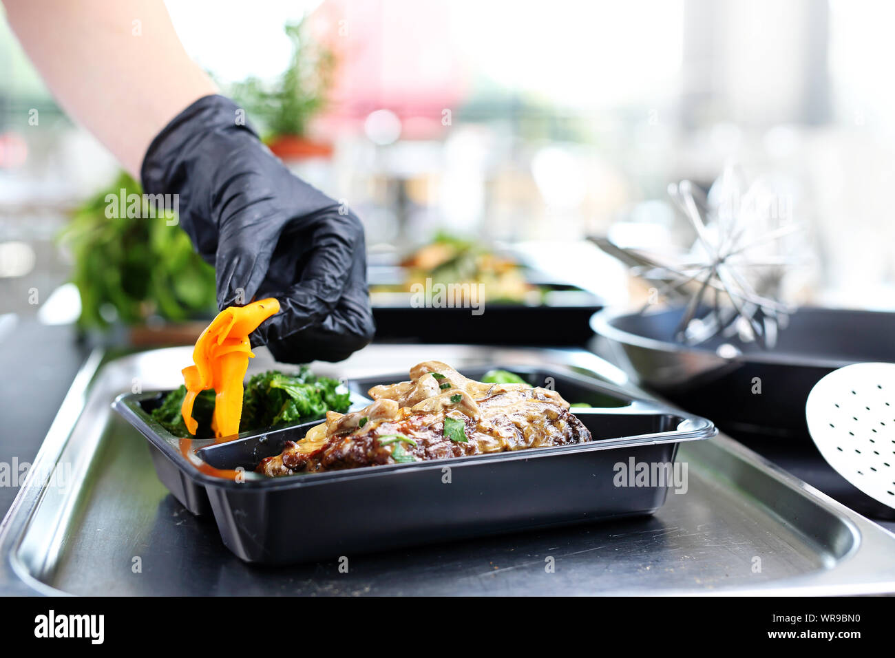 Catering. Meal prep.The cook prepares take-out dishes Stock Photo - Alamy