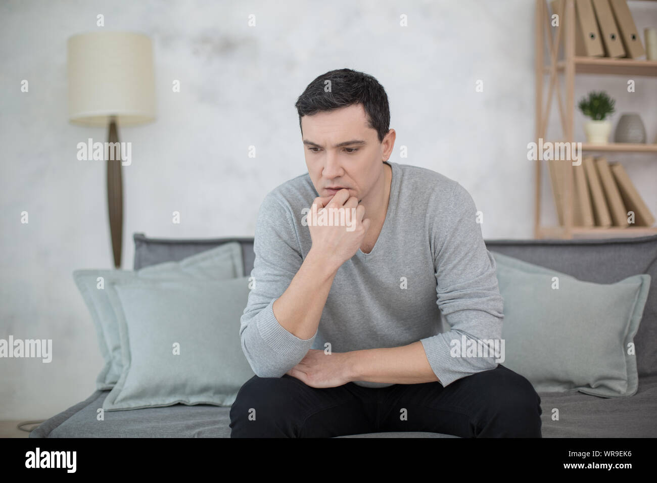 Man sitting upset psychology session mental health care Stock Photo - Alamy