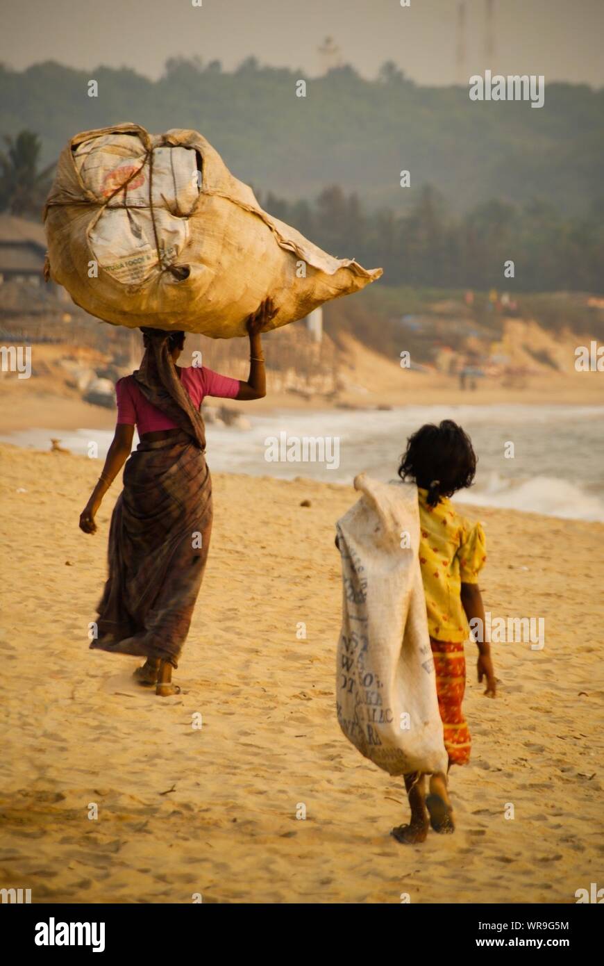 Woman carrying sack hi-res stock photography and images - Alamy