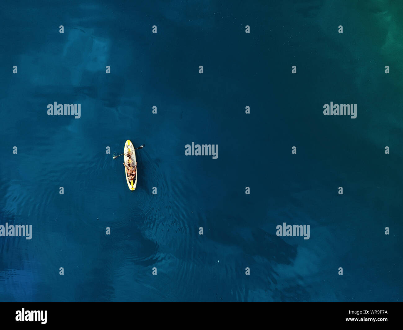 Young woman lying on surf board hi-res stock photography and images - Alamy