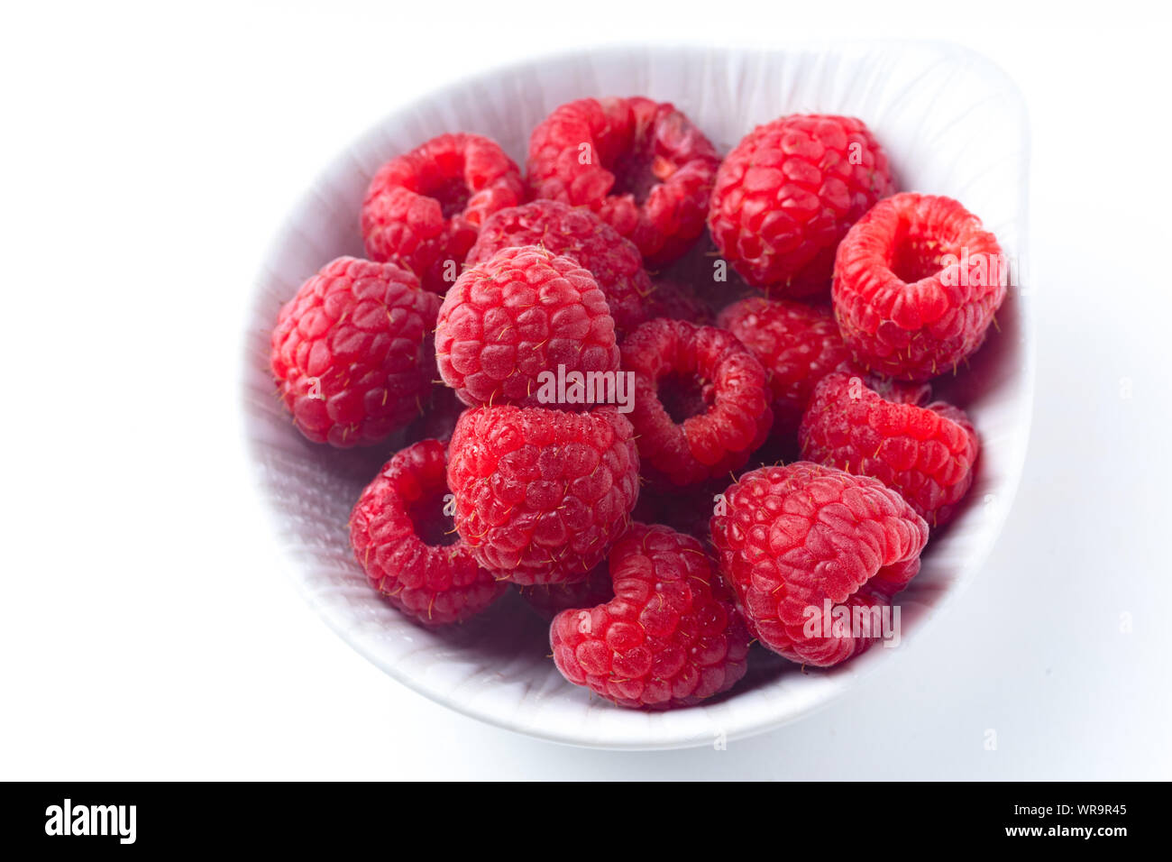 Fresh raspberries in ceramic bowl isolated on white background Stock ...