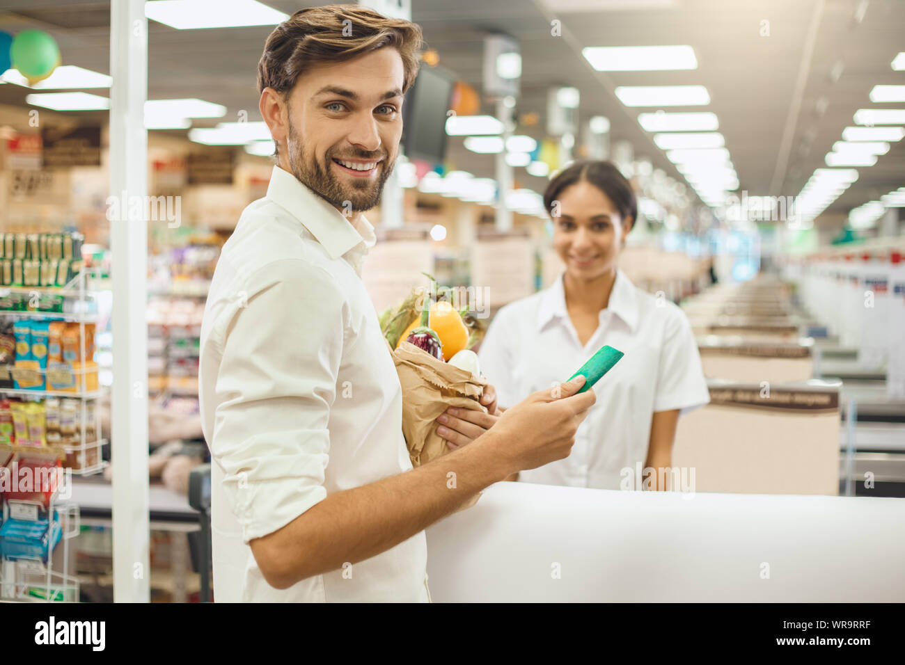 Man buying food products in the supermarket shopping Stock Photo - Alamy