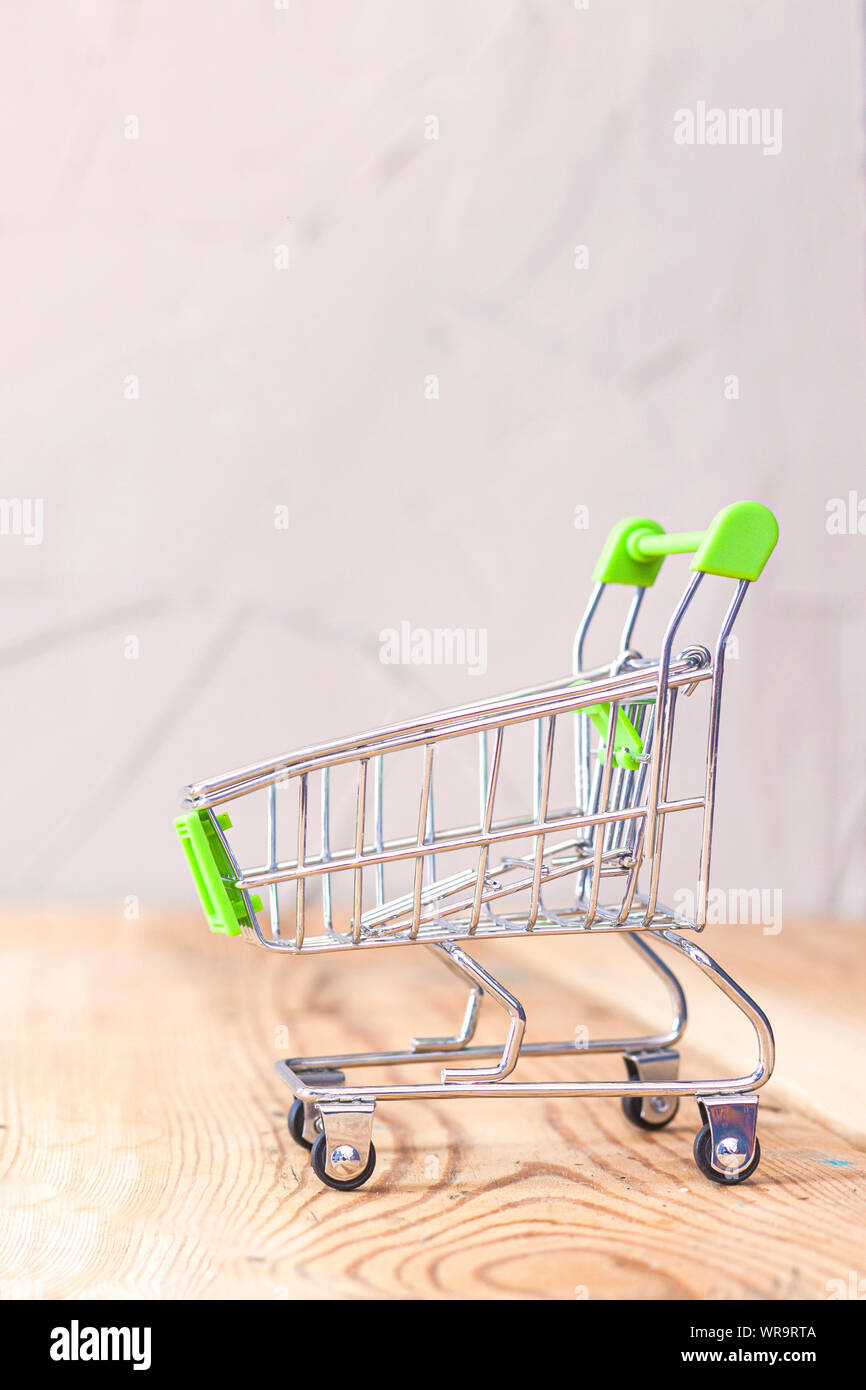 A miniature trolley shopping cart on wooden desk Stock Photo - Alamy