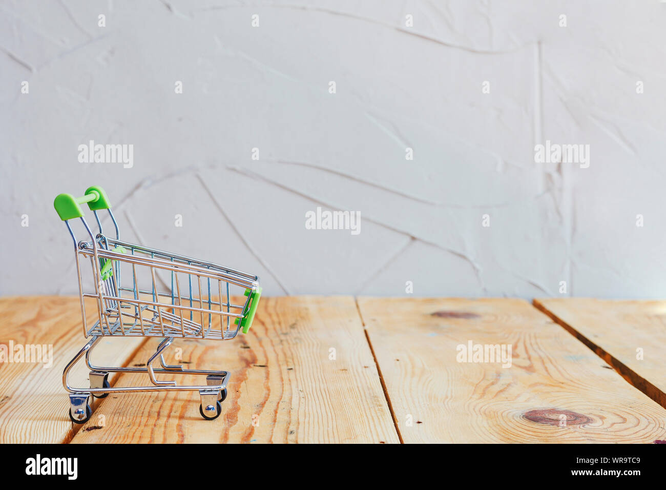 A miniature trolley shopping cart on wooden desk Stock Photo - Alamy