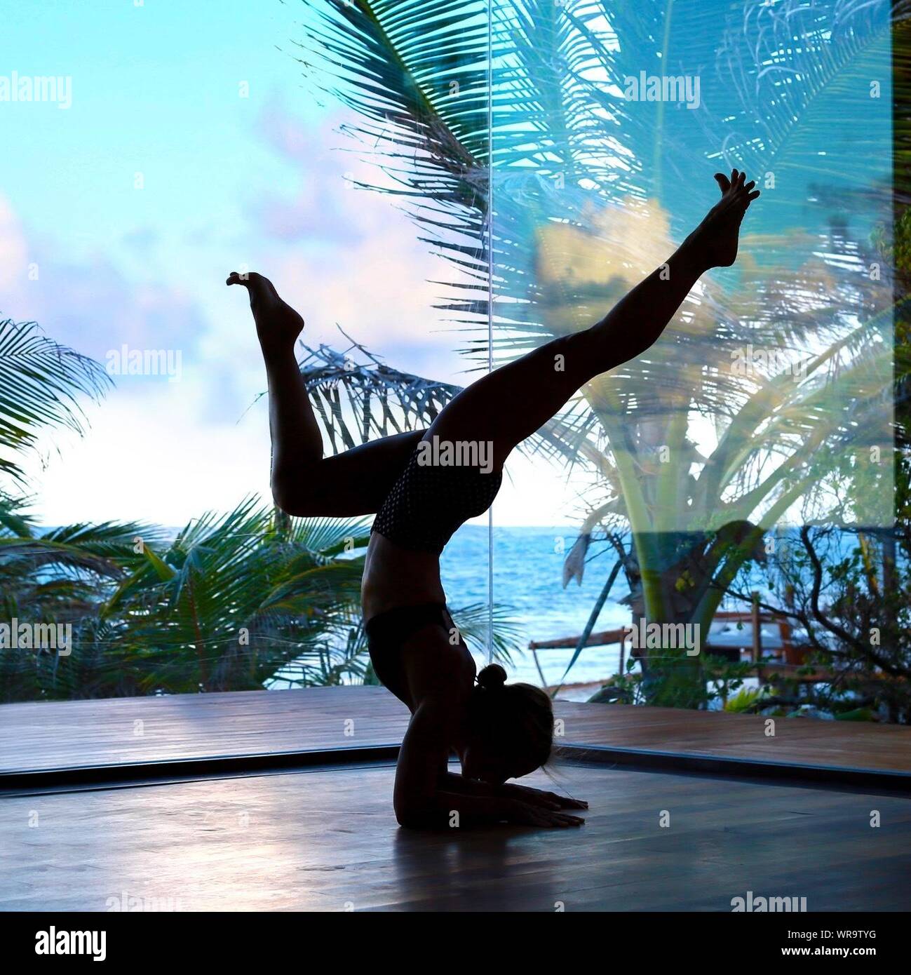 Woman practicing yoga handstand hi-res stock photography and images - Alamy