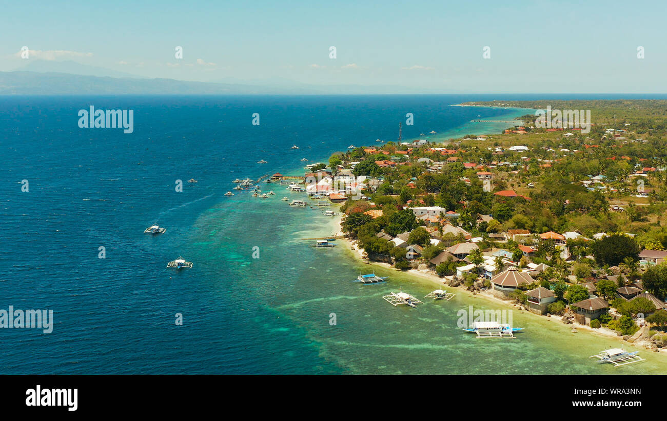 Coral reef and turquoise water with Philippine boats in the famous ...
