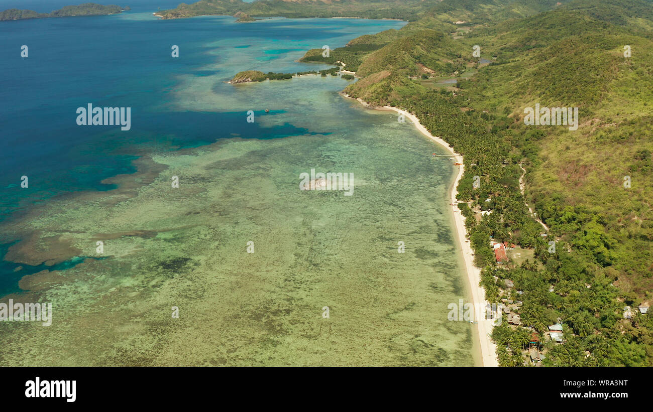 Aerial view tropical island with beach, coral reef and blue lagoon ...