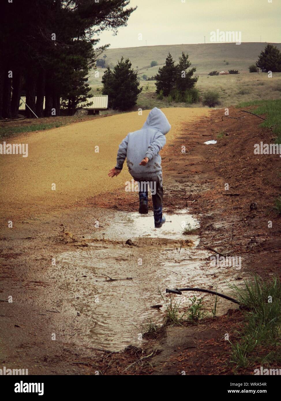 Boys jumping puddle hi-res stock photography and images - Alamy