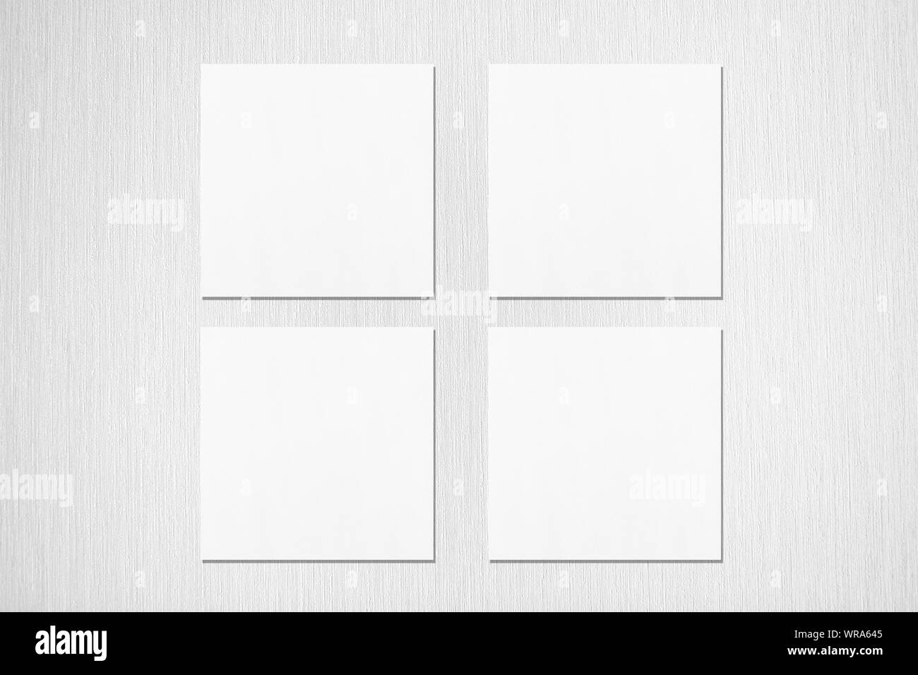 Four empty white square flyer or business card mockups with soft ...