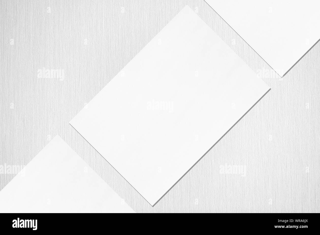 Close up of three empty white rectangle poster or card mockups lying ...