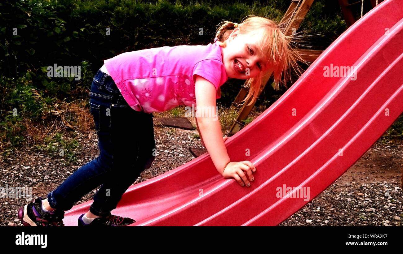 Blond girl on slide hi-res stock photography and images - Alamy