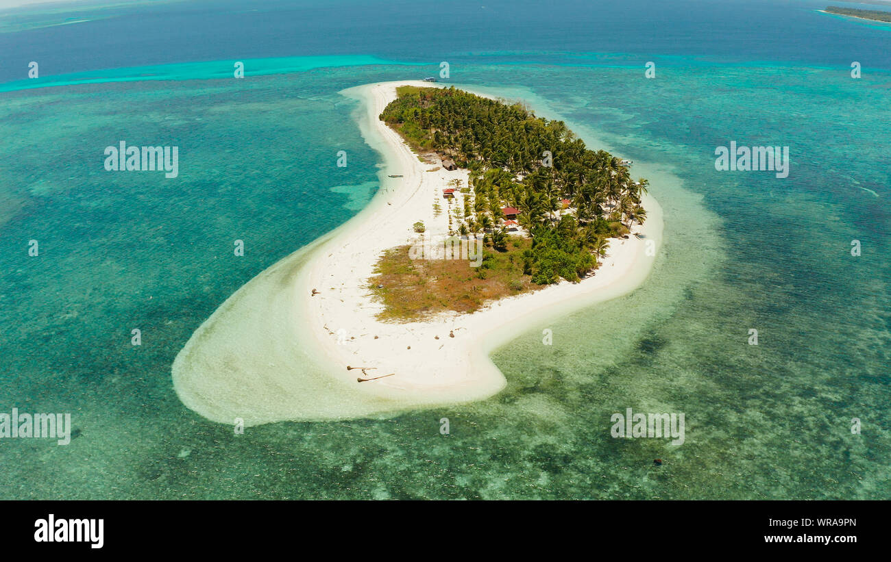 Tropical island Canimeran with sandy beach in the blue sea with coral ...