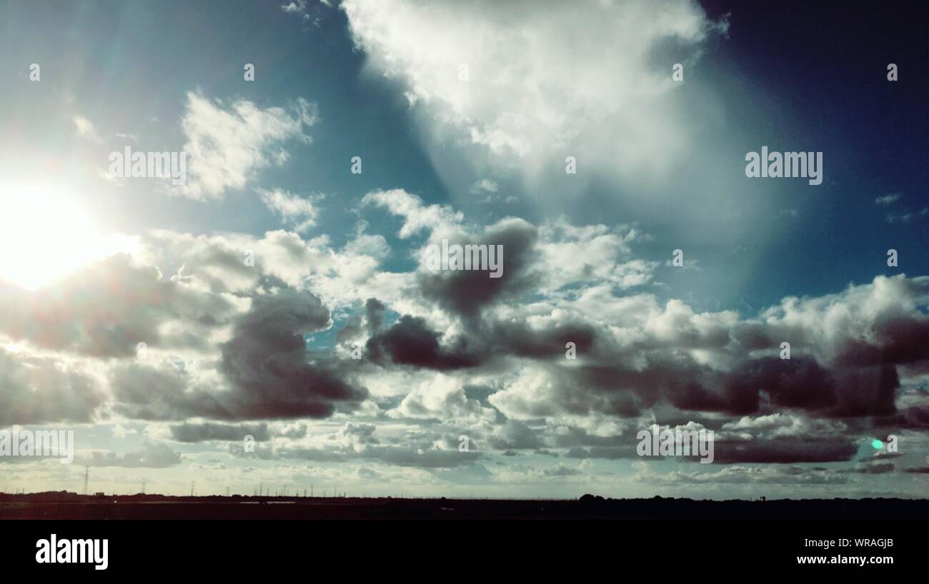 Sun shining through storm clouds hi-res stock photography and images ...