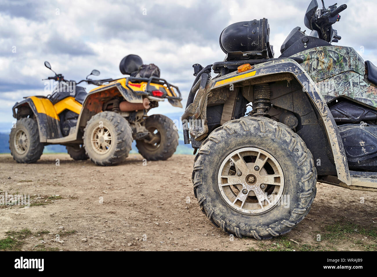 Twi quadricycles or quad bikes on the mountains background on a cloudy ...