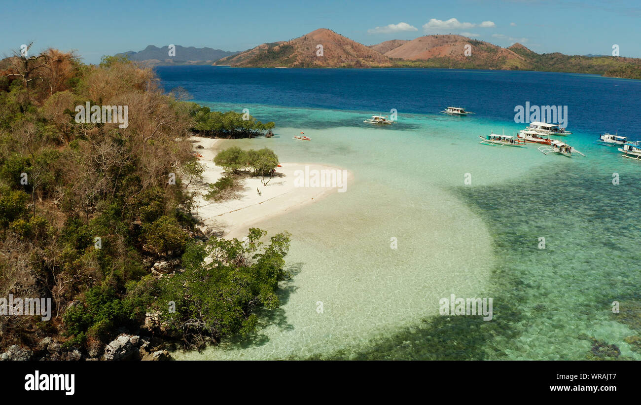 aerial seascape tourists enjoy tropical beach. tropical island with ...