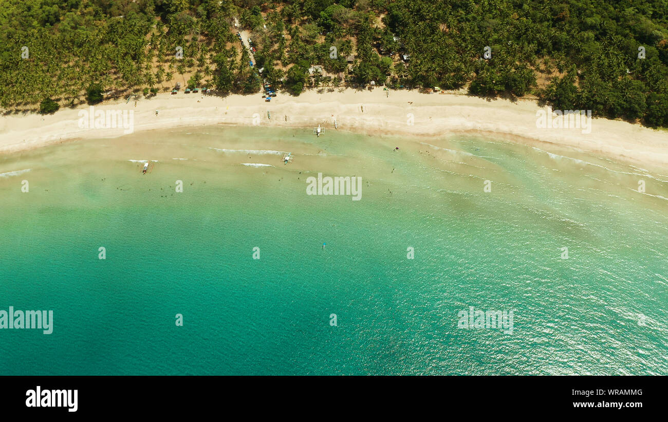 Beautiful tropical beach in cove with blue lagoon and turquoise water ...