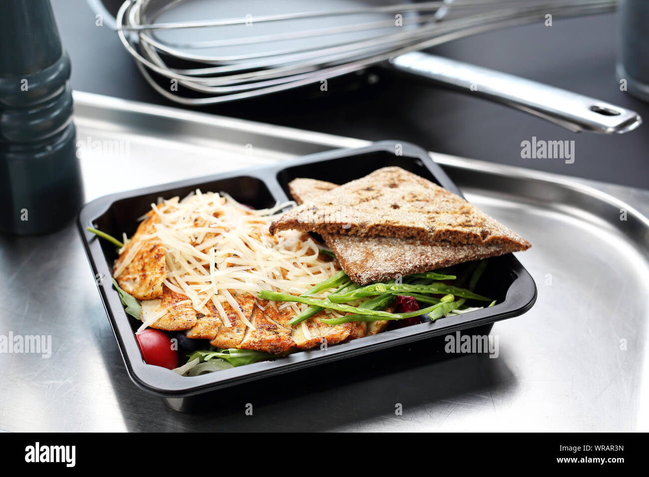 Takeaway food in a box. Chicken fillet with wholemeal bread and ...