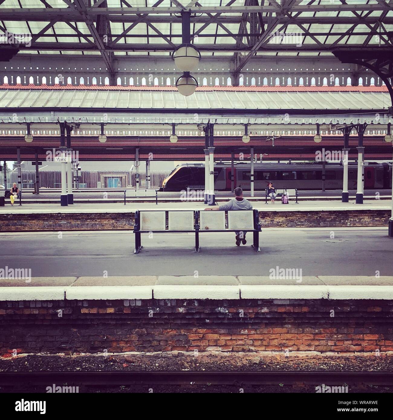 Man train station bench hi-res stock photography and images - Alamy
