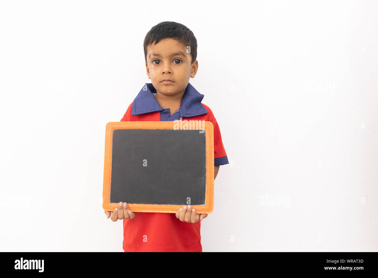 Concept of child protest showing with young boy holding black slate on ...