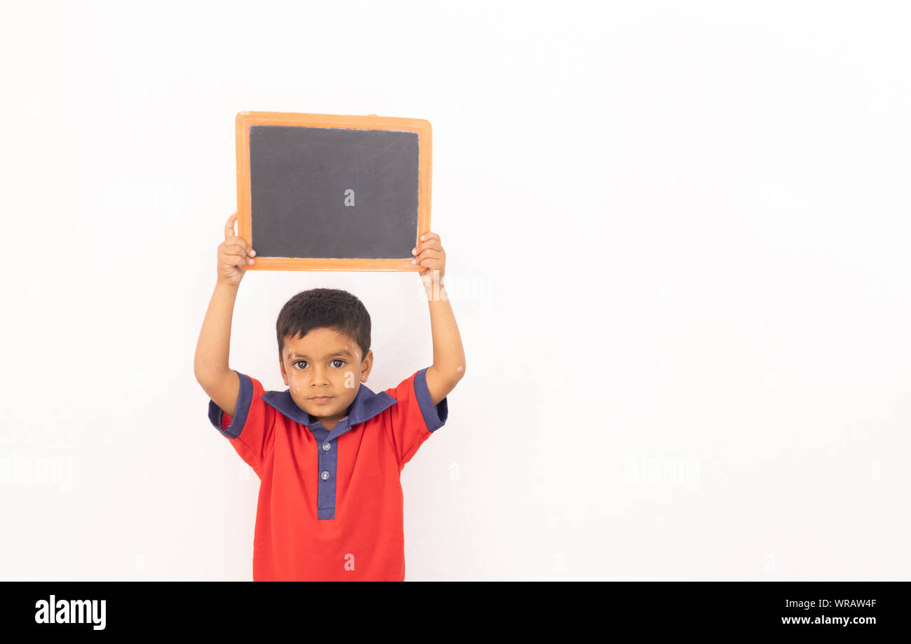 Concept of child protest showing with young boy holding black slate on ...
