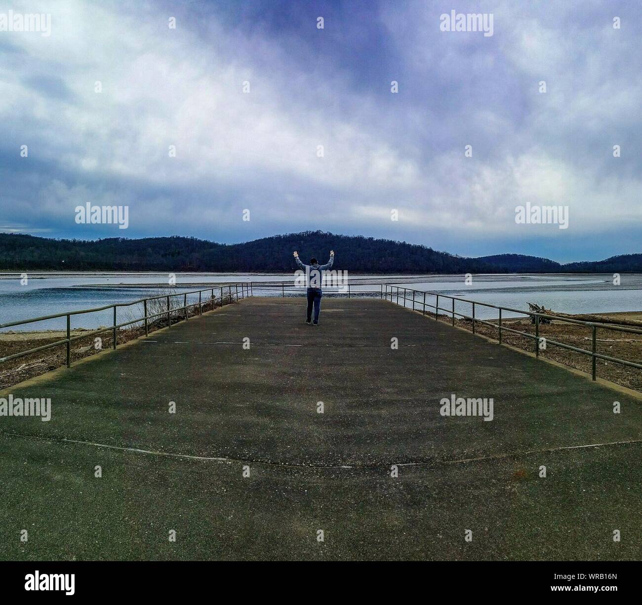 Young man standing on jetty at lake hi-res stock photography and images ...