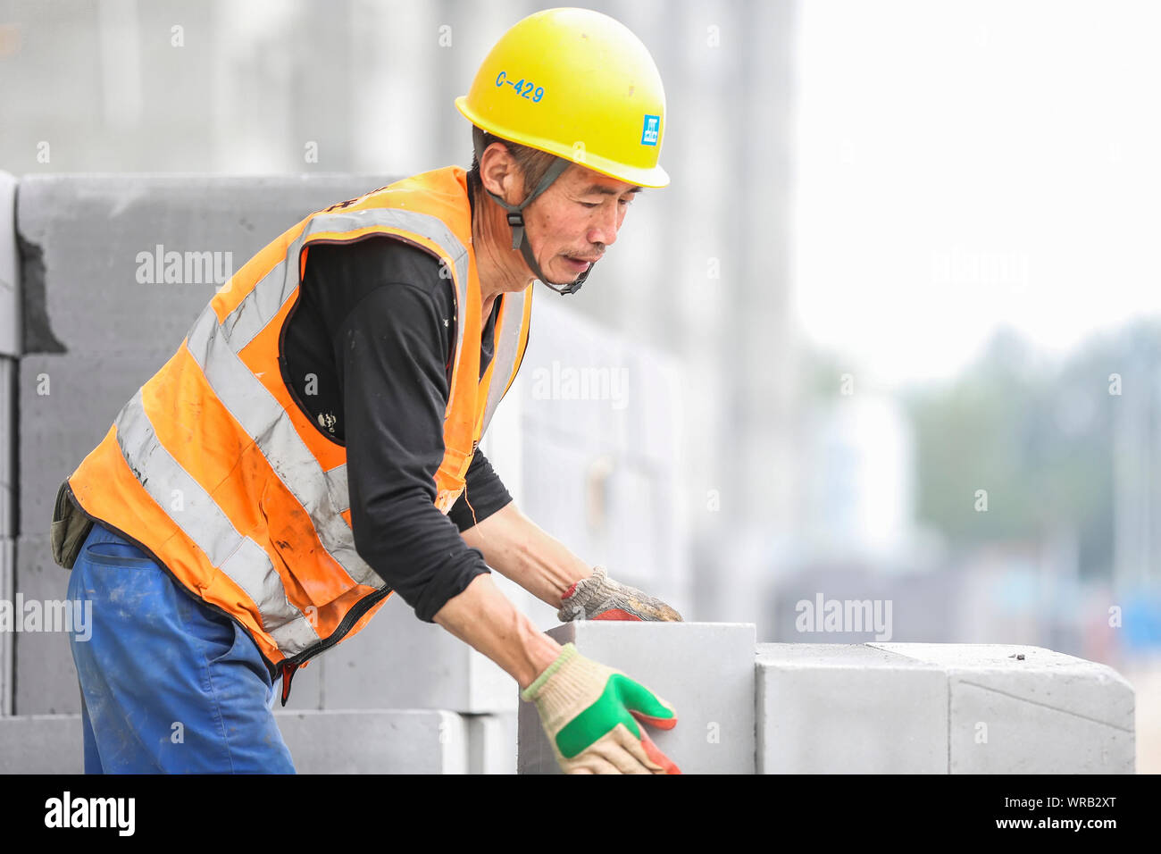 A Chinese migrant worker constructs a high-rise residential apartment ...