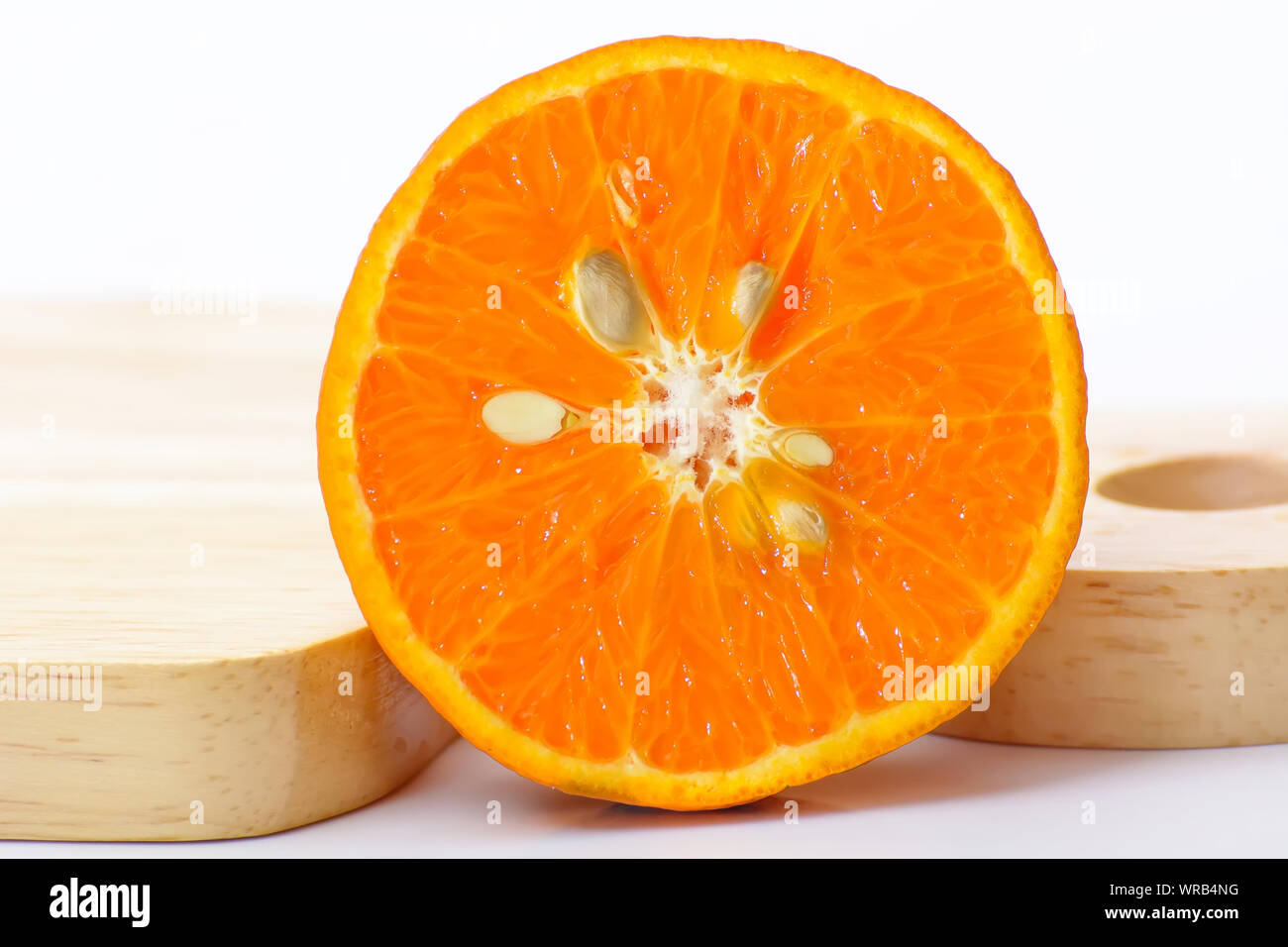 Orange shogun cut in half and cutting boards on a white background ...