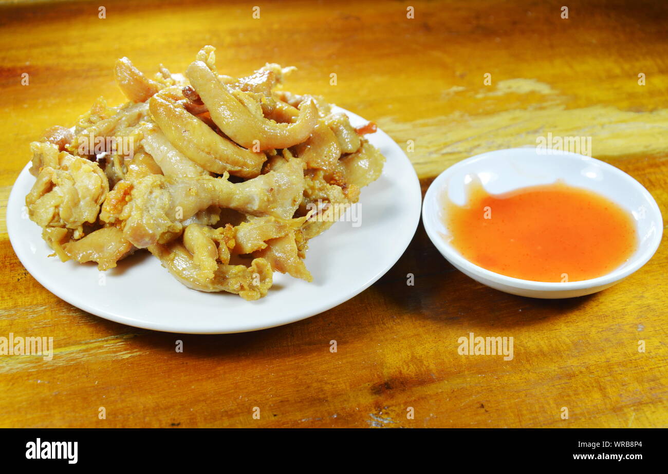 deep fried chicken dipping with chili sauce Stock Photo - Alamy