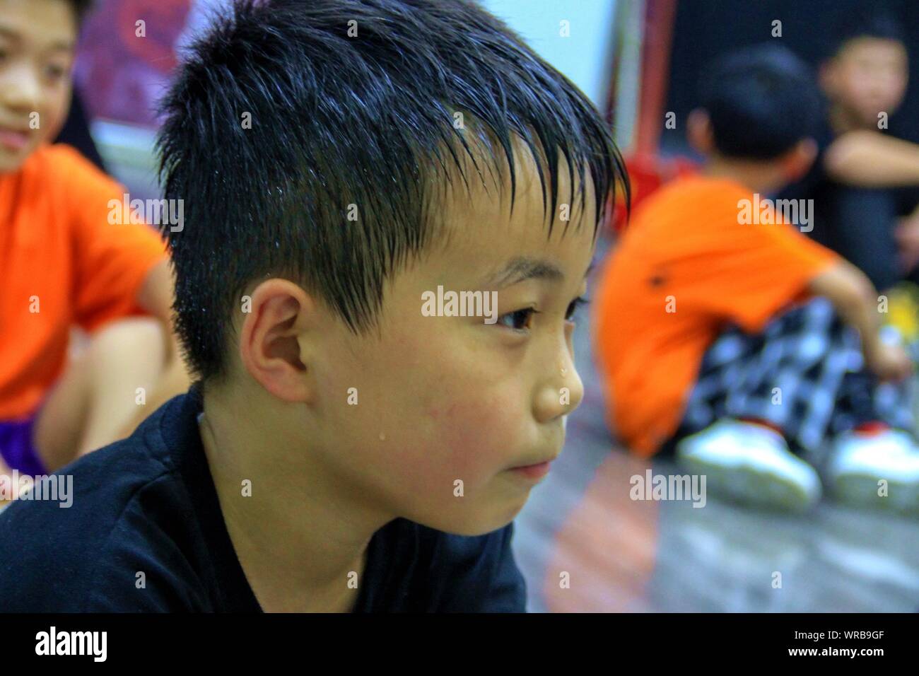 A young Chinese student sweats all over as he and others practise ...