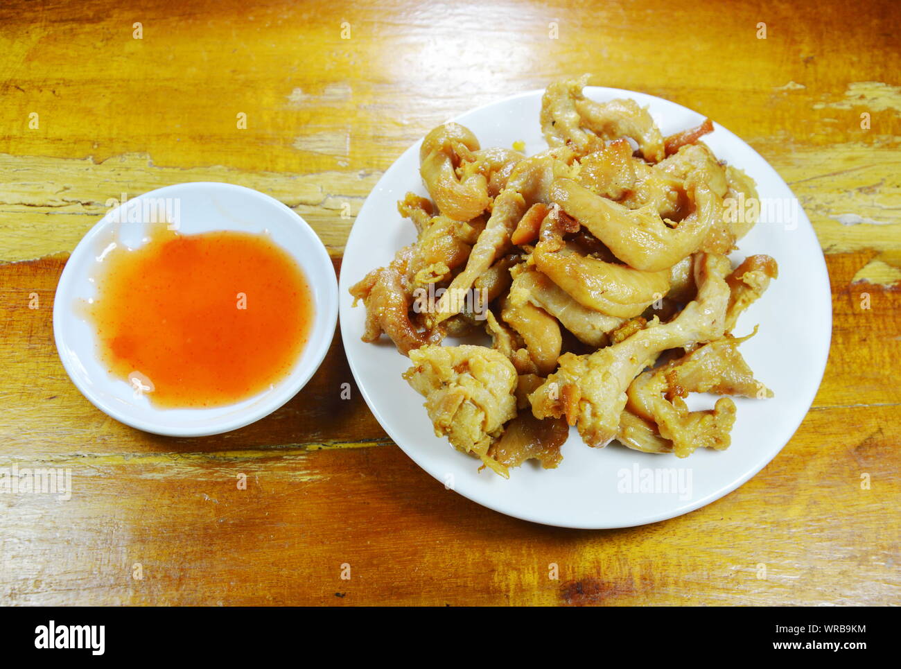 deep fried chicken dipping with chili sauce Stock Photo - Alamy